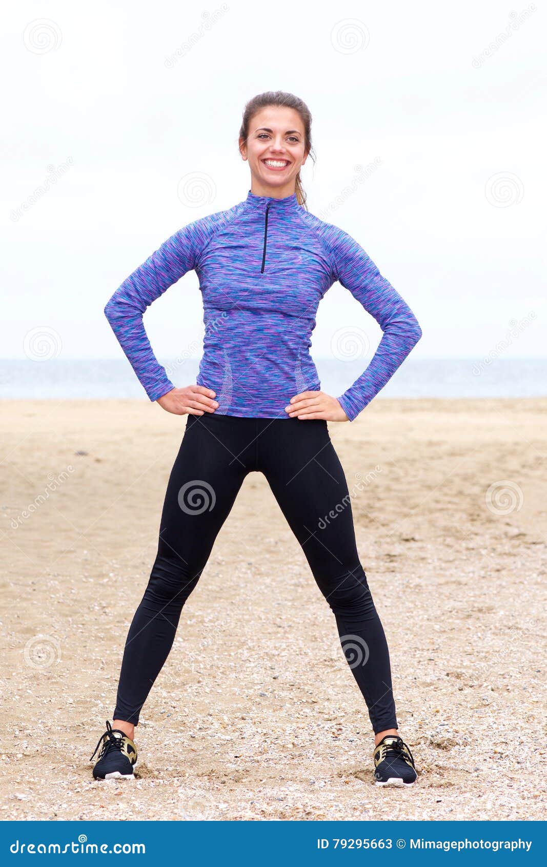 Smiling Athlete Standing on Beach with Hands on Hips Stock Image ...