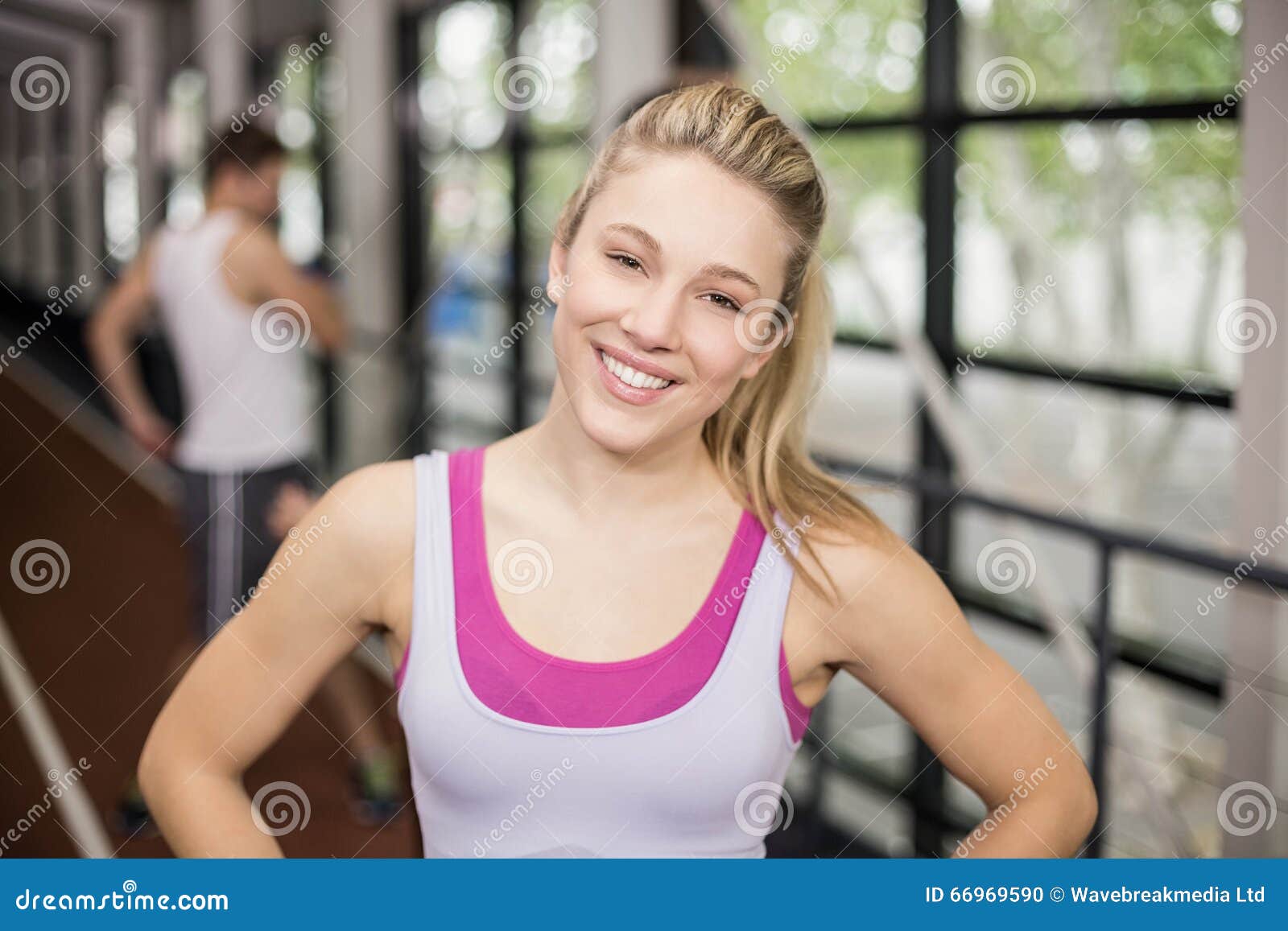 Smiling Athletic Woman Posing with Hands on Hips Stock Photo - Image of ...