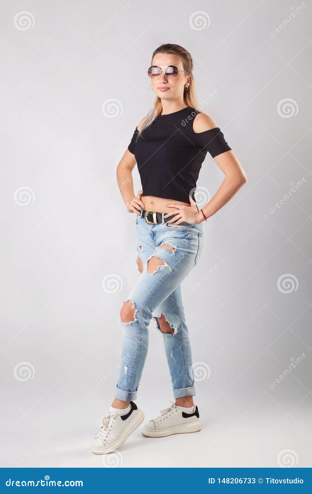 Smiling Attractive Woman In Jeans And T Shirt Posing And Looking At