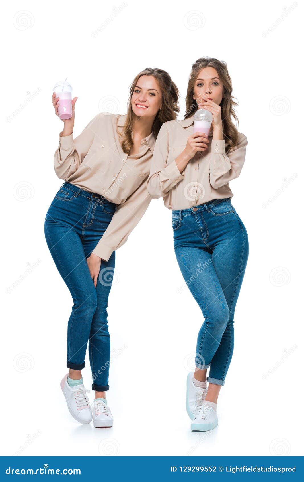 Smiling Attractive Young Twins Drinking Milkshakes Stock Photo - Image ...