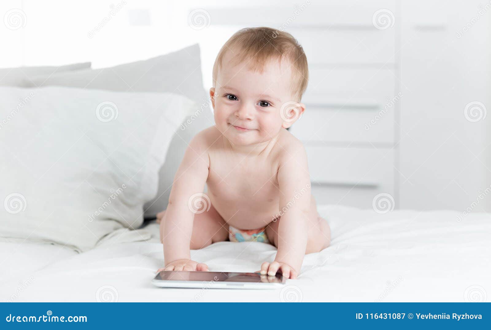 Portrait of Smiling Baby Boy in Diapers Crawling Towards Digital Tablet ...