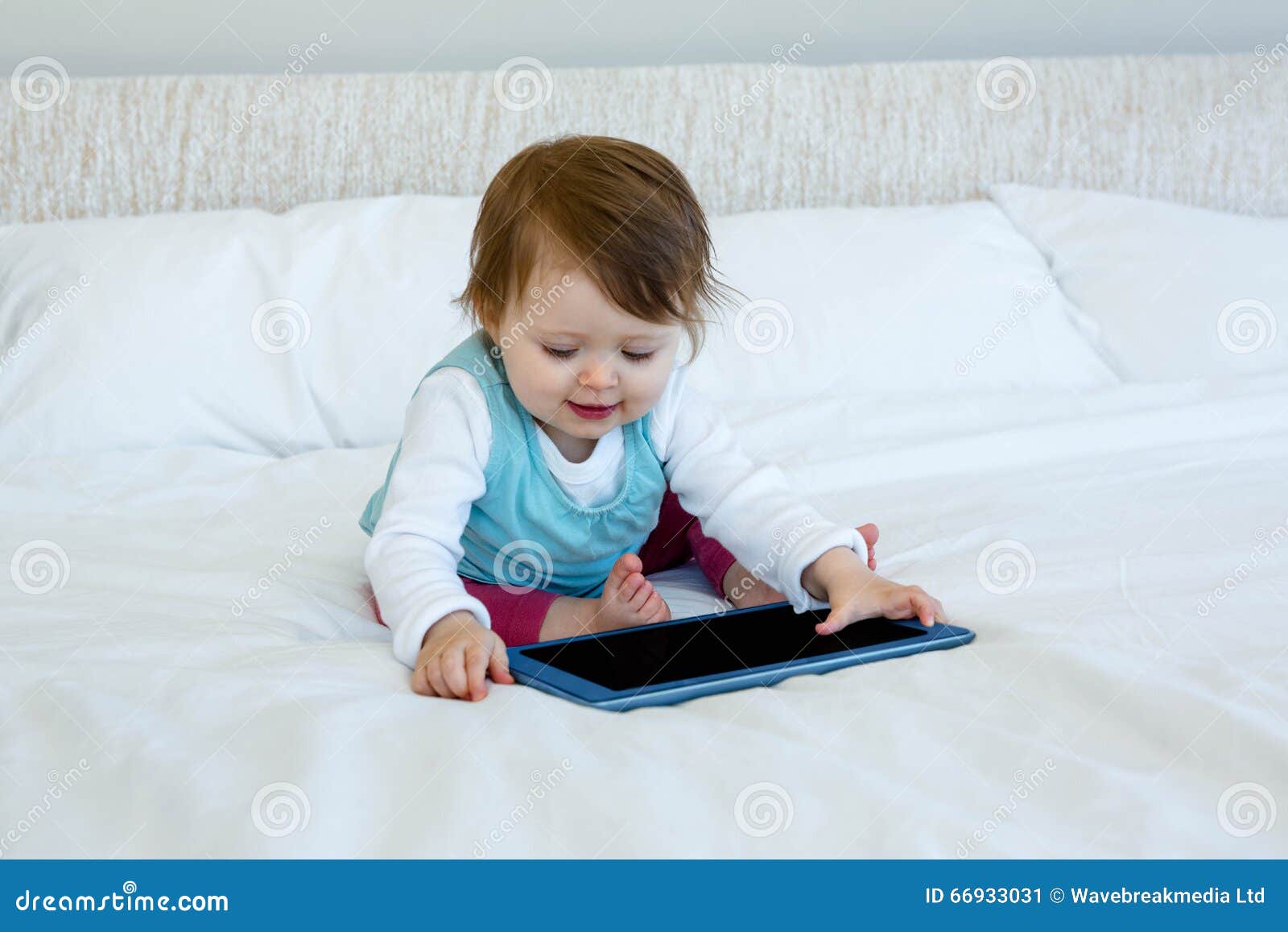Smiling Baby Playing with a Tablet Stock Image - Image of duvet ...