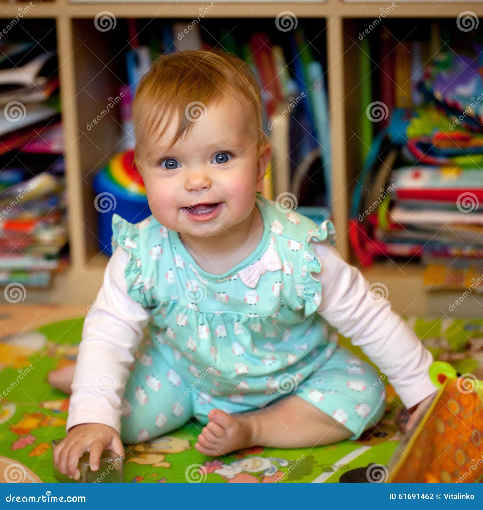 Smiling Baby Sitting on Floor in Nursery Stock Photo - Image of ...