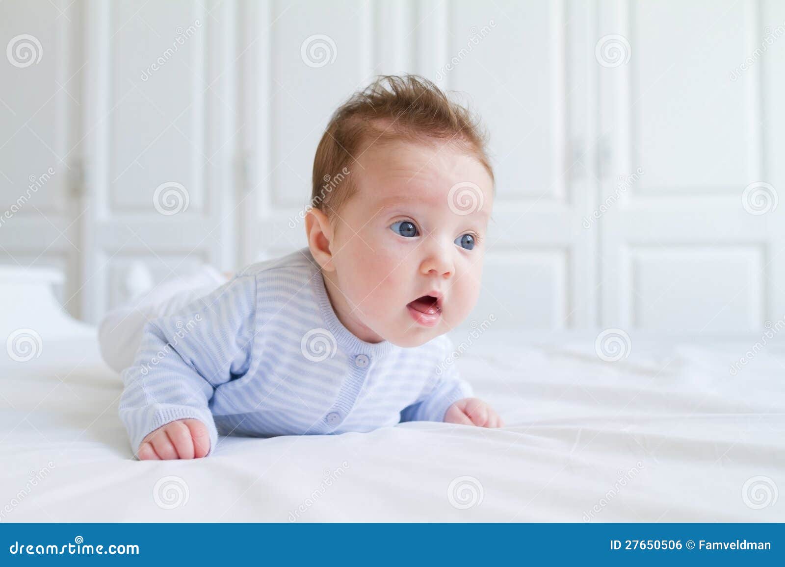 Smiling Baby Tummy Time in a White Nursery Stock Photo - Image of ...