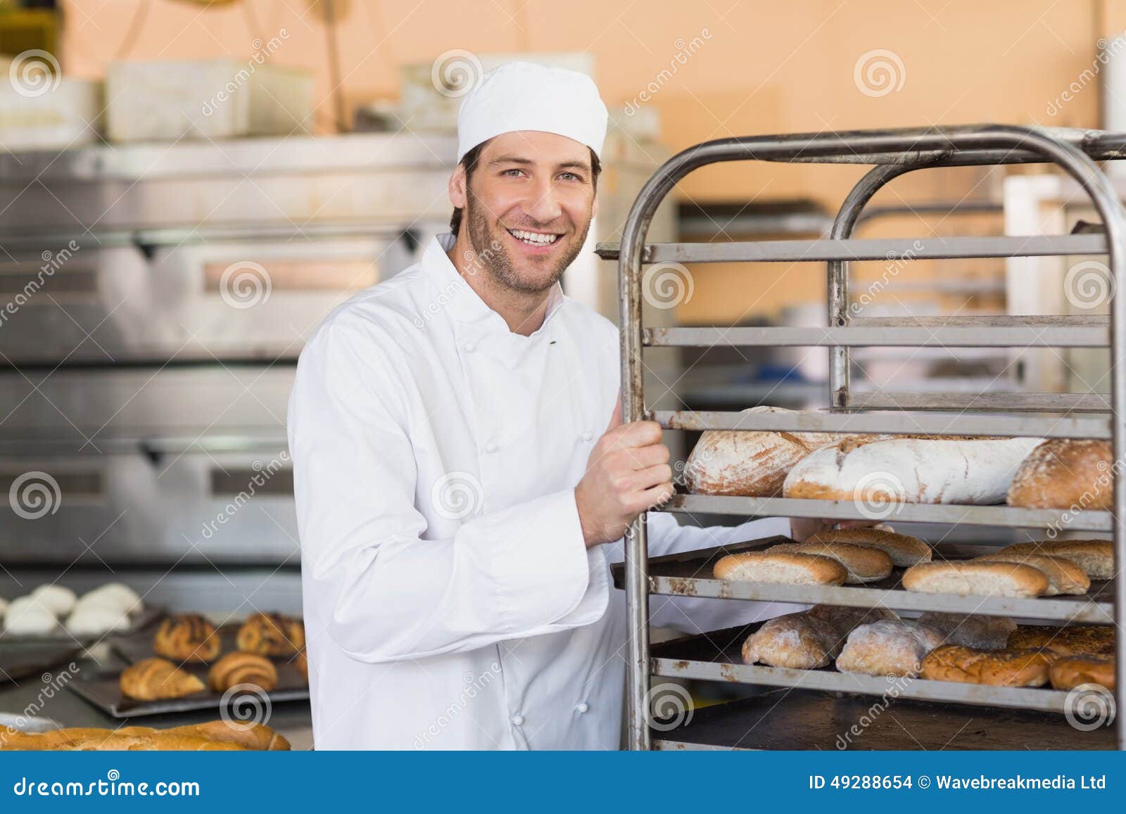 Smiling Baker Pushing Tray of Bread Stock Photo - Image of chefs, food ...
