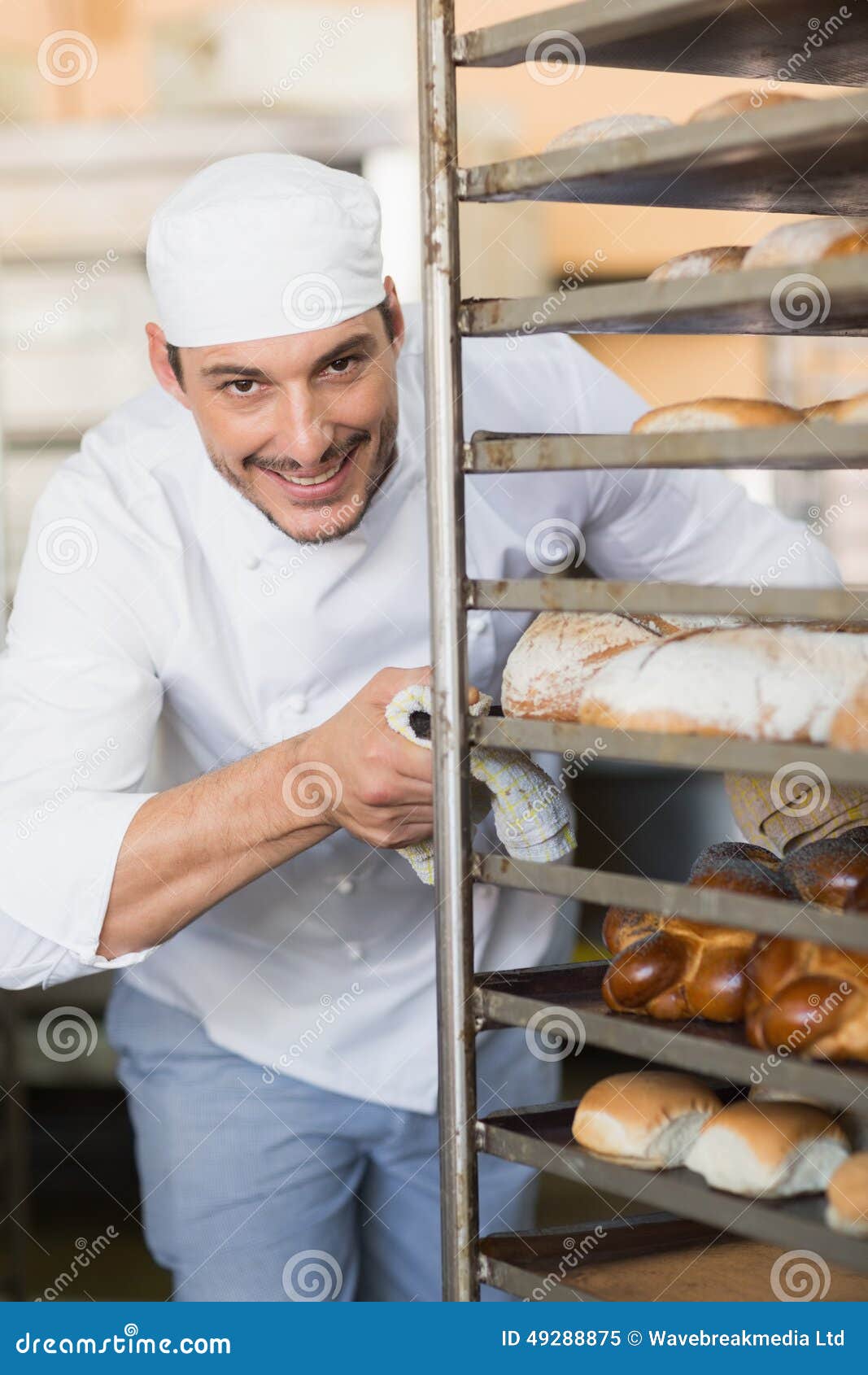 Smiling Baker Pushing Tray of Bread Stock Image - Image of adult, food ...