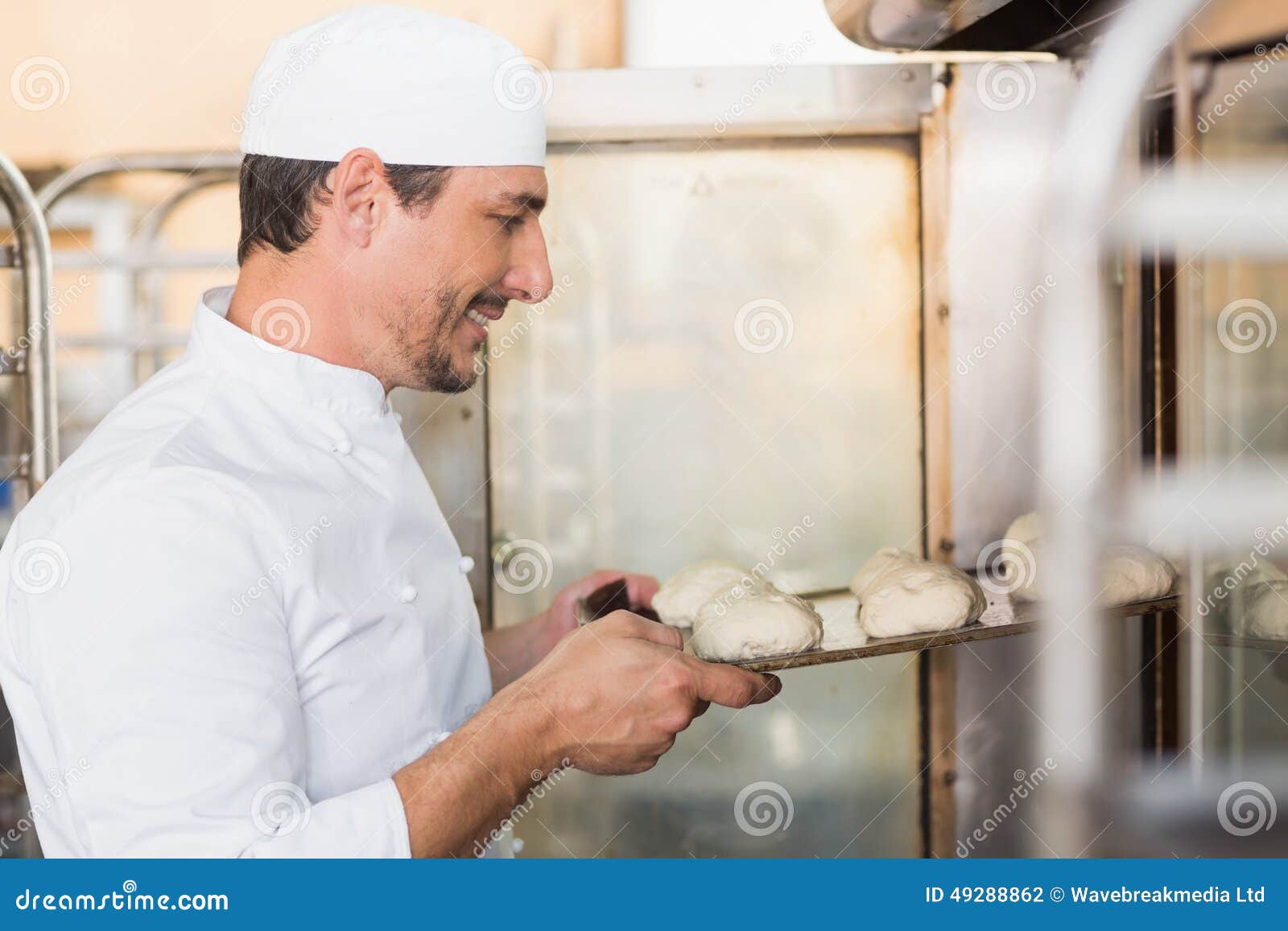 Smiling Baker Putting Dough in Oven Stock Photo - Image of kitchen ...