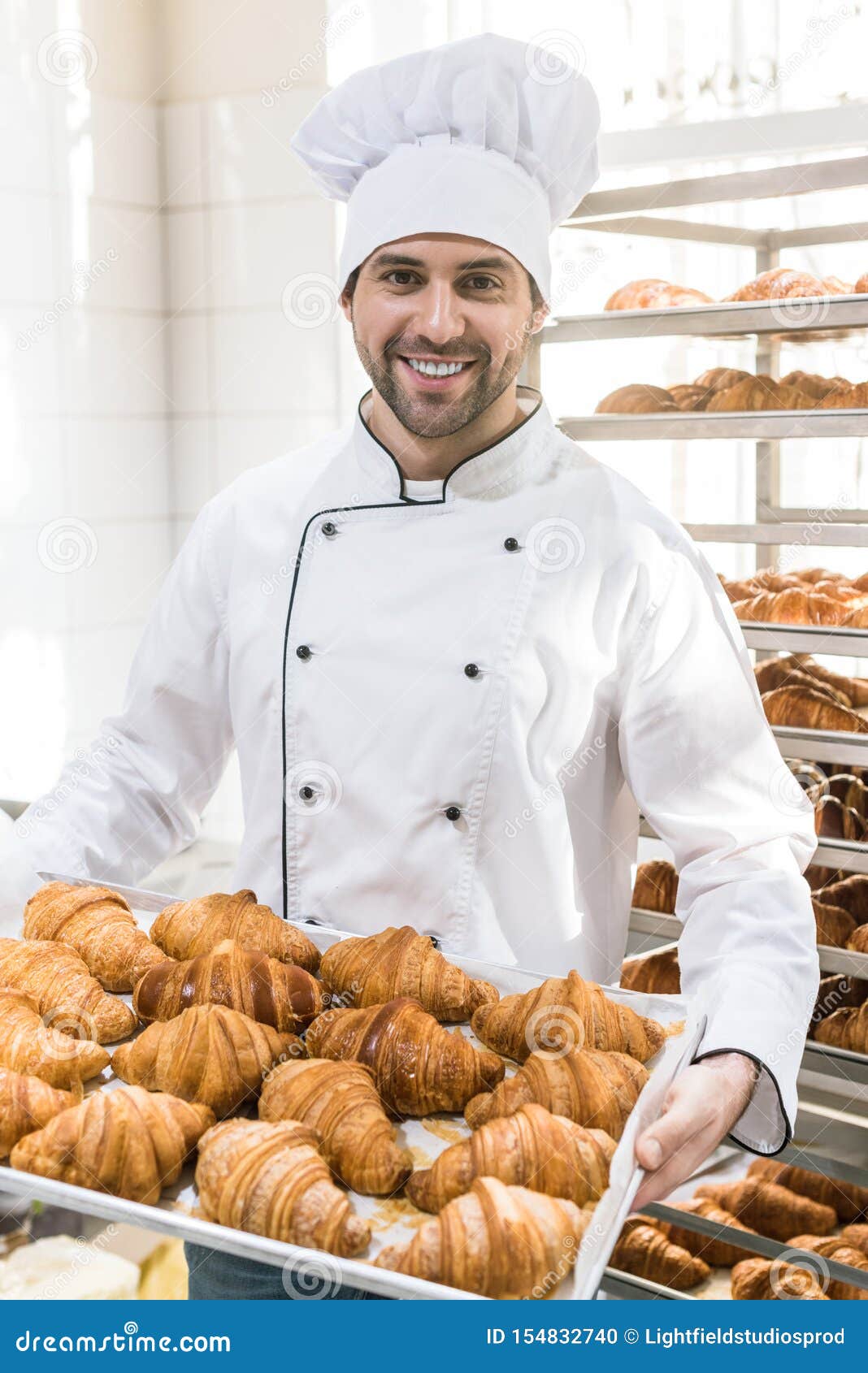 Smiling Baker in White Chefs Uniform with Tray Full Stock Photo - Image ...