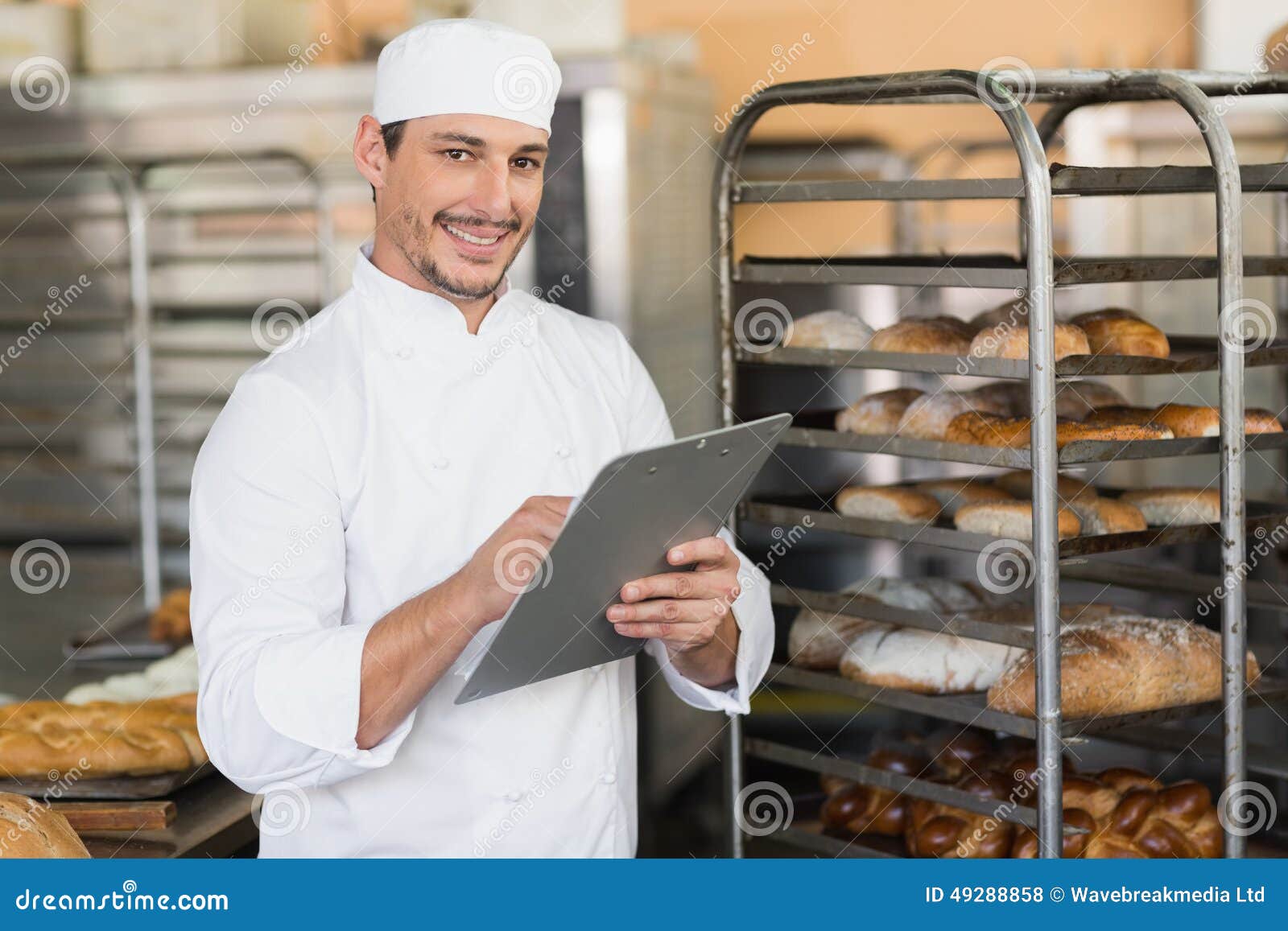 Smiling Baker Writing on Clipboard Stock Photo - Image of business ...