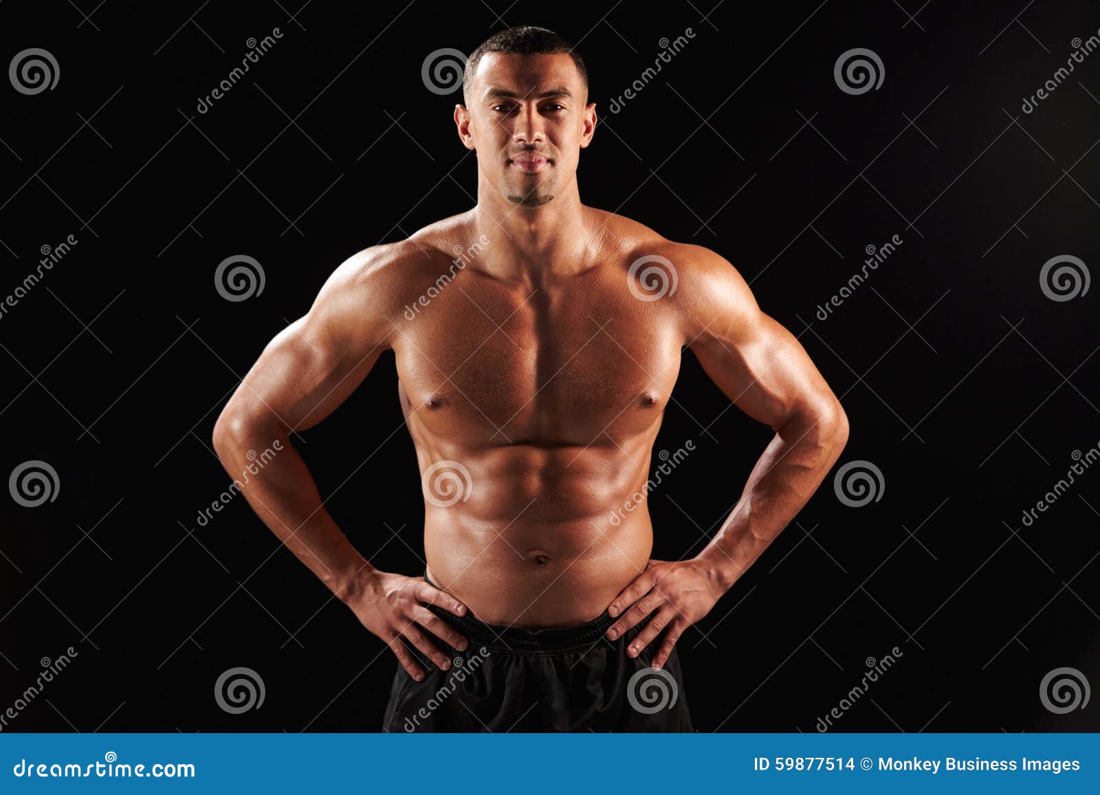 Smiling Bare Chested Male Body Builder with Hands on Hips Stock Photo ...