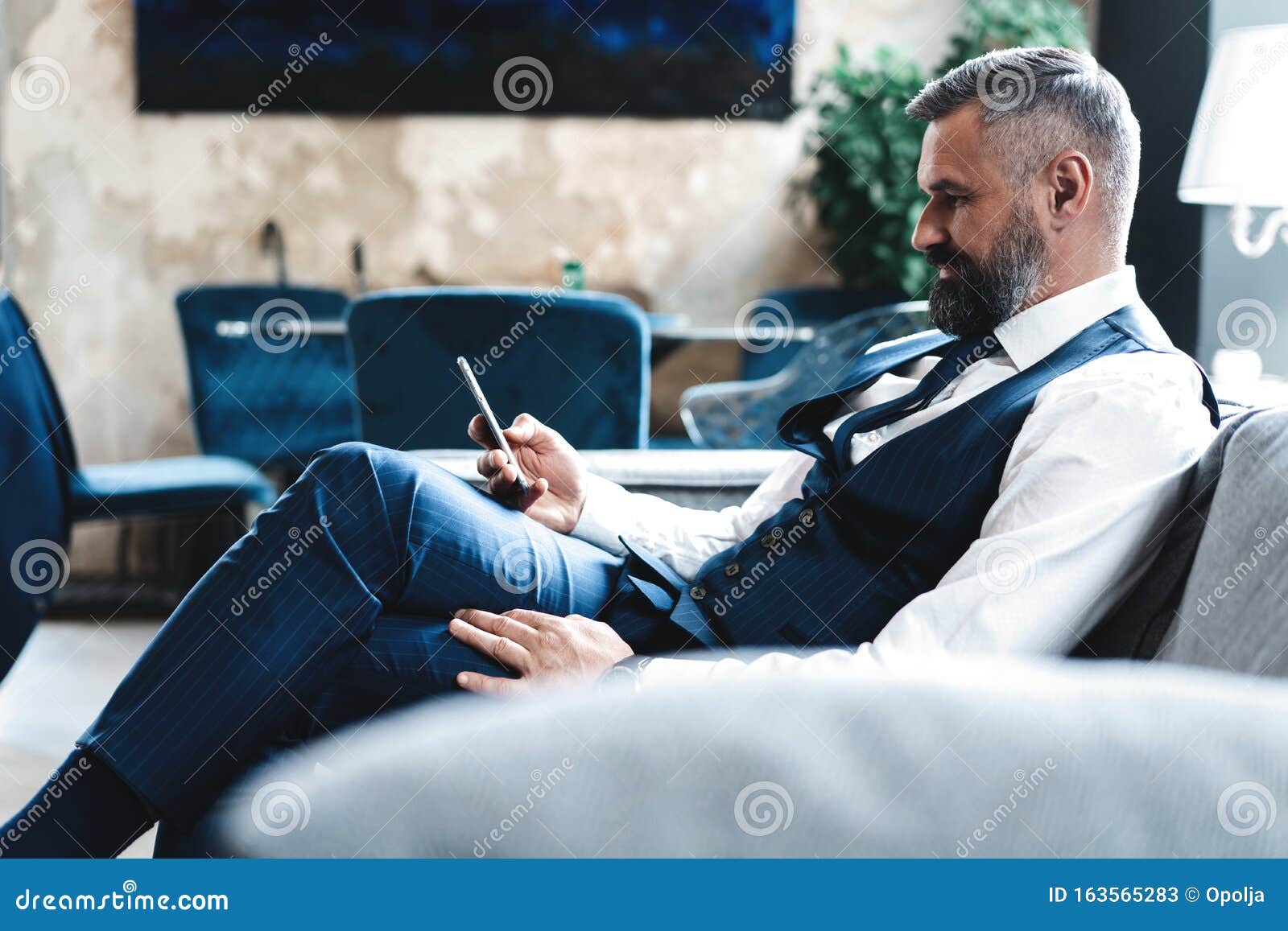 Smiling Bearded Man Making Text Message on Smartphone while Sitting ... Smiling Bearded Man Making Text Message on Smartphone while Sitting ...