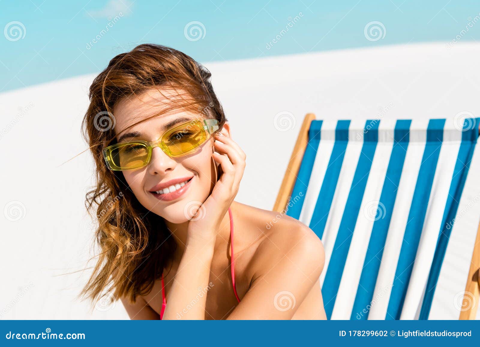 Beautiful Girl In Swimsuit And Sunglasses Sitting In Deck Chair On