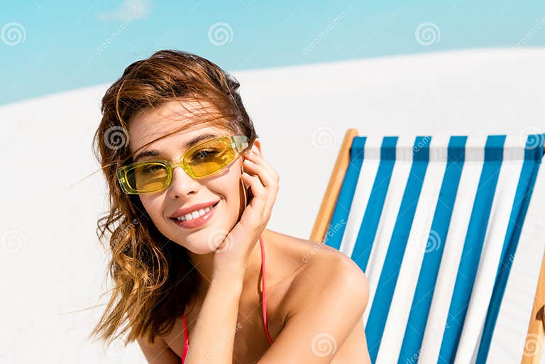 Beautiful Girl In Swimsuit And Sunglasses Sitting In Deck Chair On