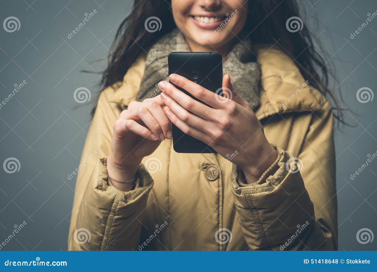 Smiling Beautiful Woman with Mobile Phone Stock Photo - Image of jacket ...