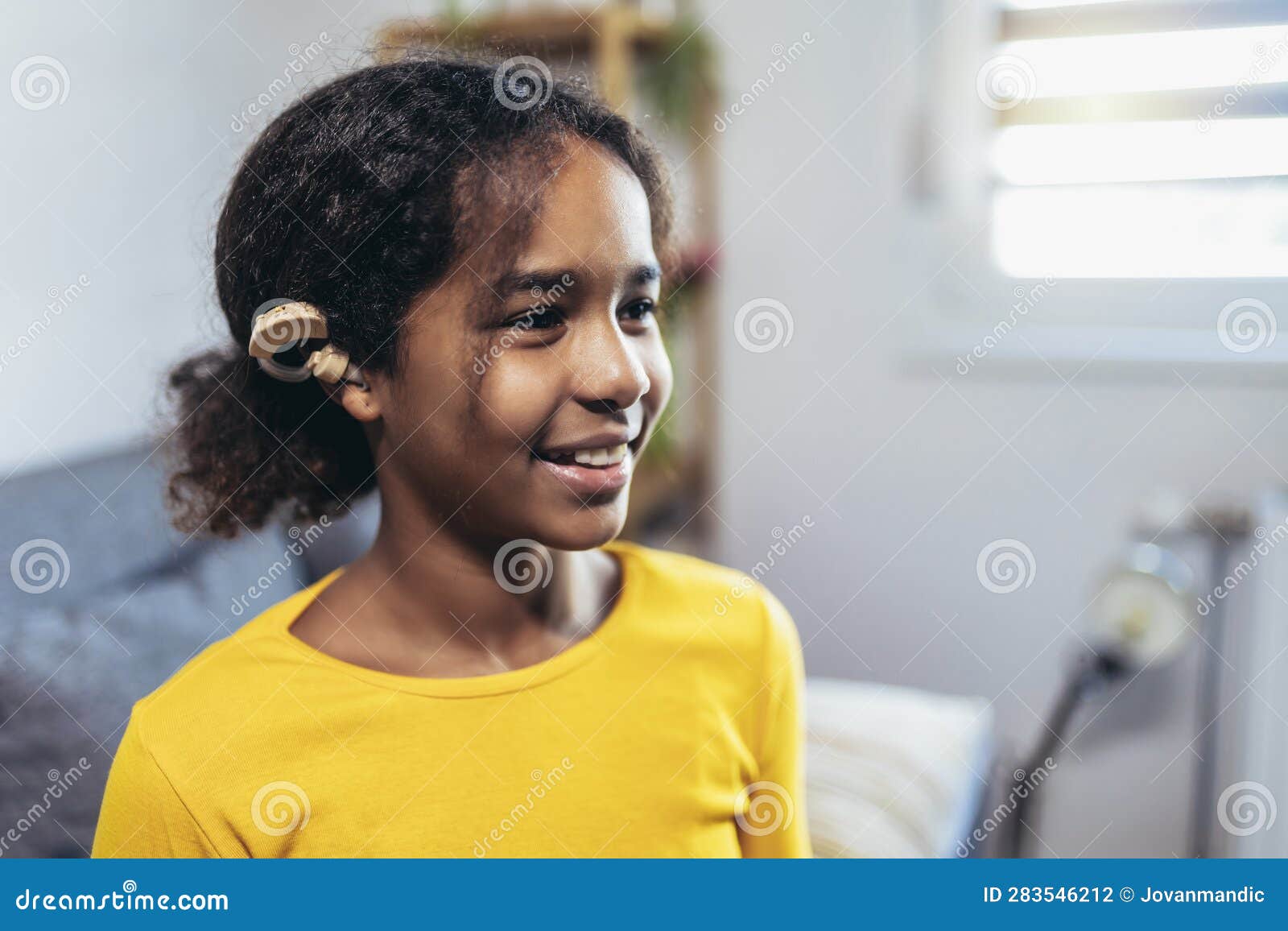 Smiling Black Deaf Girl Wearing a Hearing Aid Stock Photo - Image of ...