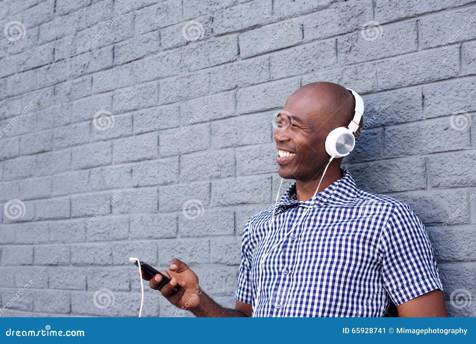 Smiling Black Guy with Headphones and Mobile Phone Stock Image - Image ...