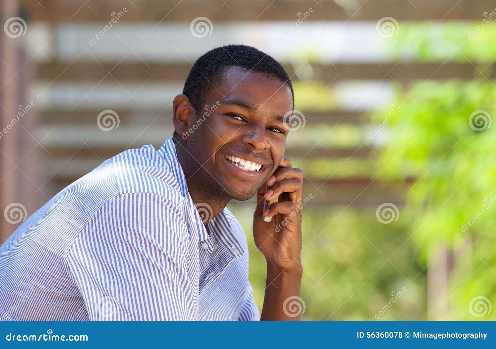 Smiling Black Guy Using Mobile Phone Outside Stock Photo - Image of ...