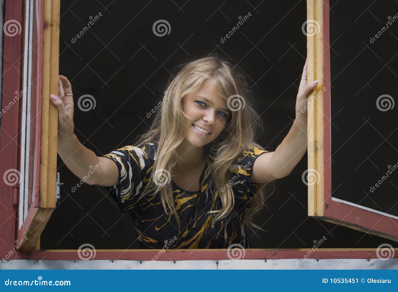 Smiling Blond Girl Opening Leaves of a Window Stock Image - Image of ...