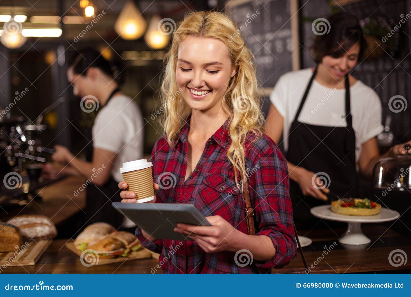 Smiling Blonde Customer in Front of the Counter Using Tablet Stock ...