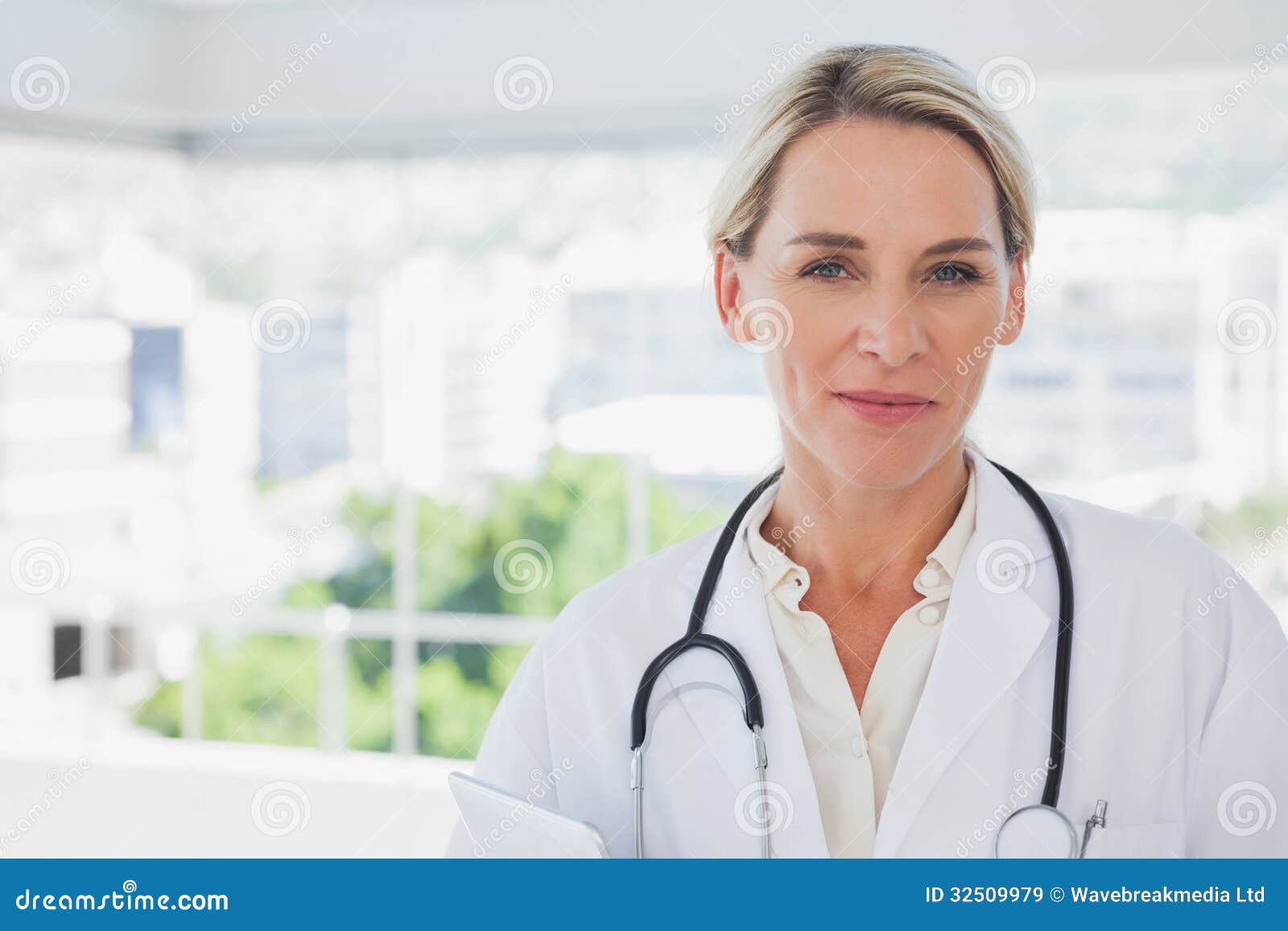 Smiling Blonde Doctor Holding a Clipboard Stock Image - Image of ...