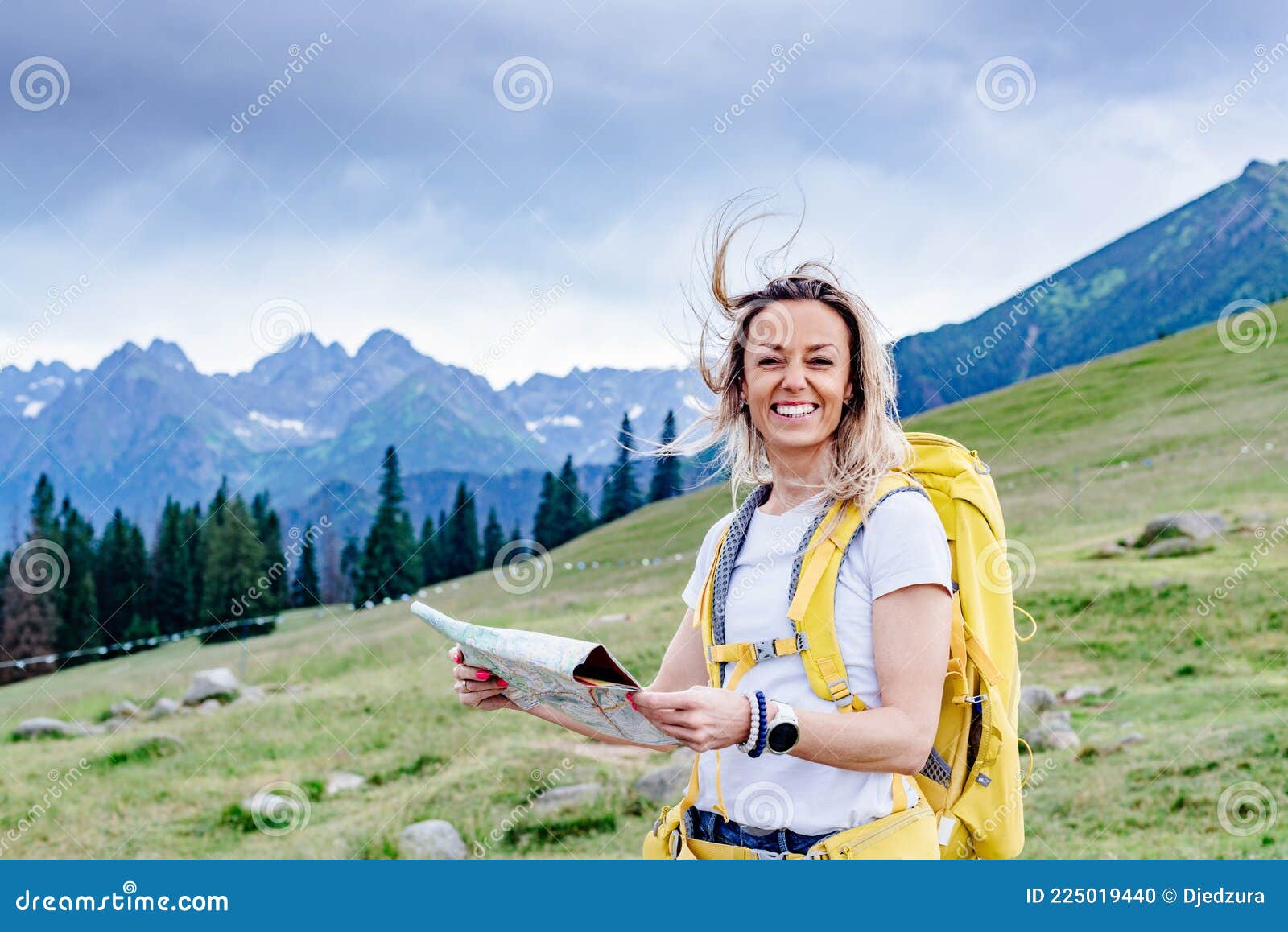 Smiling Female Hiker with Map in the Mountains. Active Recreation ...