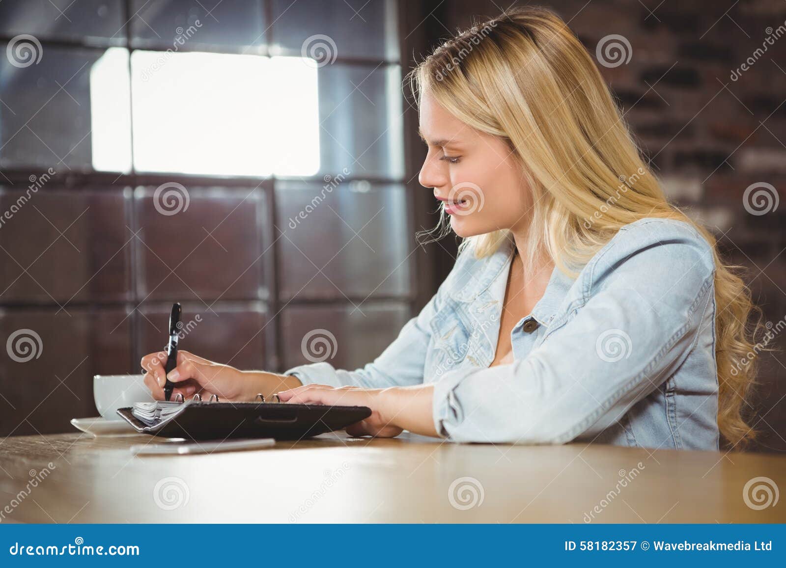 Smiling Blonde Having Coffee and Writing in Planner Stock Image - Image ...