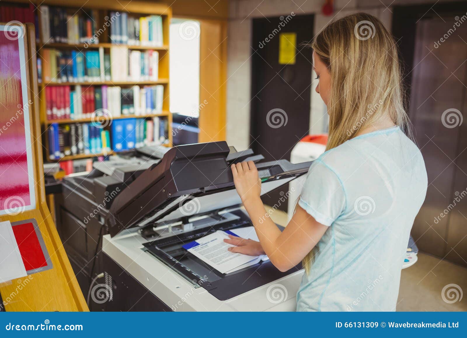 Smiling Blonde Student Making a Copy Stock Image - Image of bookshelves ...