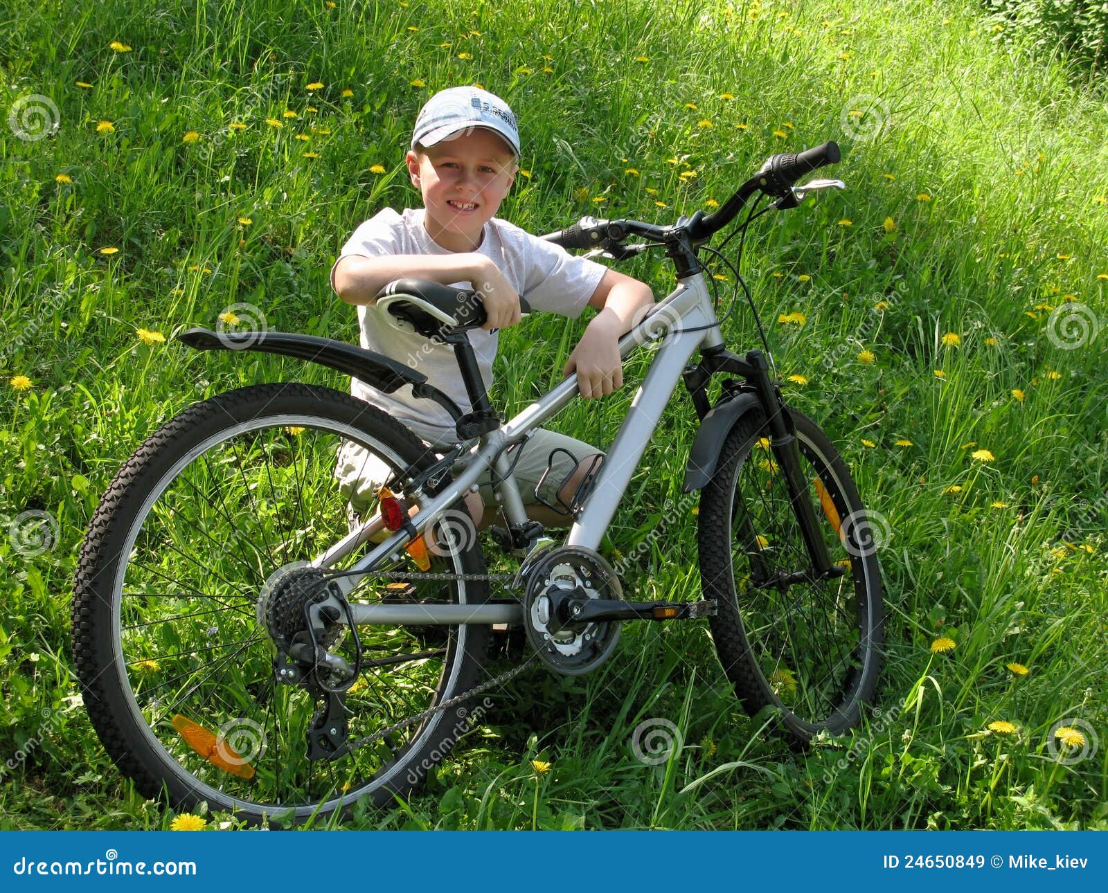 Smiling boy on bicycle stock image. Image of green, activity - 24650849