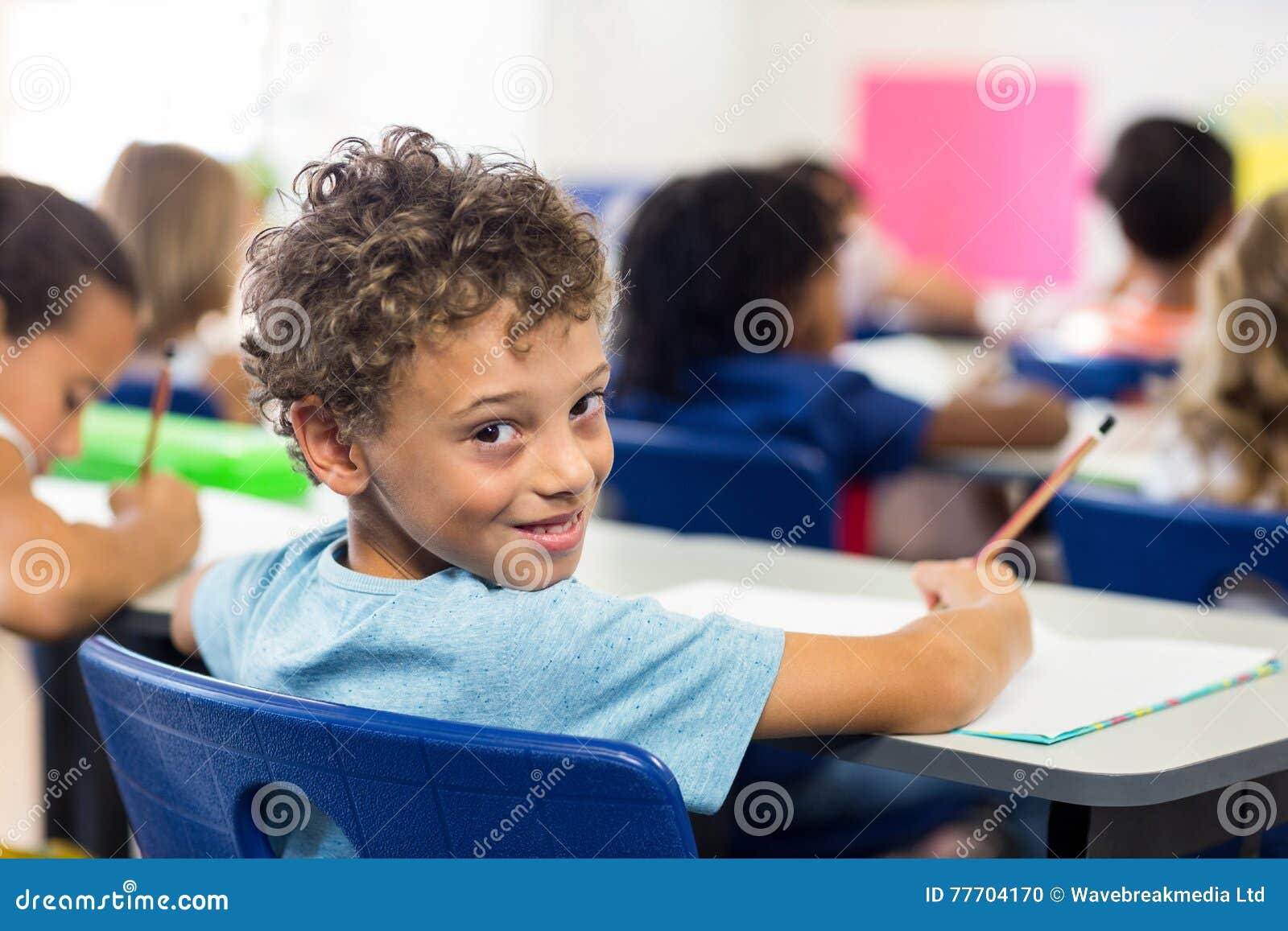 Smiling Boy with Classmates in Classroom Stock Photo - Image of head ...