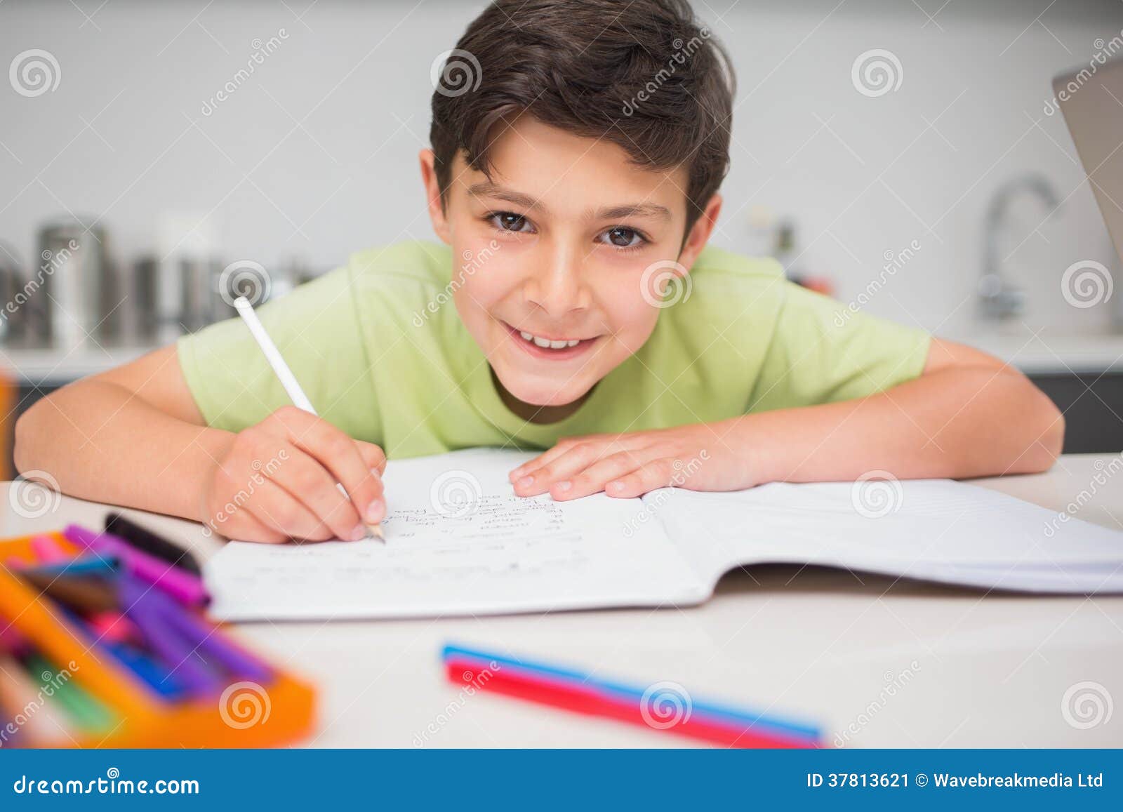 Smiling Boy Doing Homework in Kitchen Stock Image - Image of looking ...
