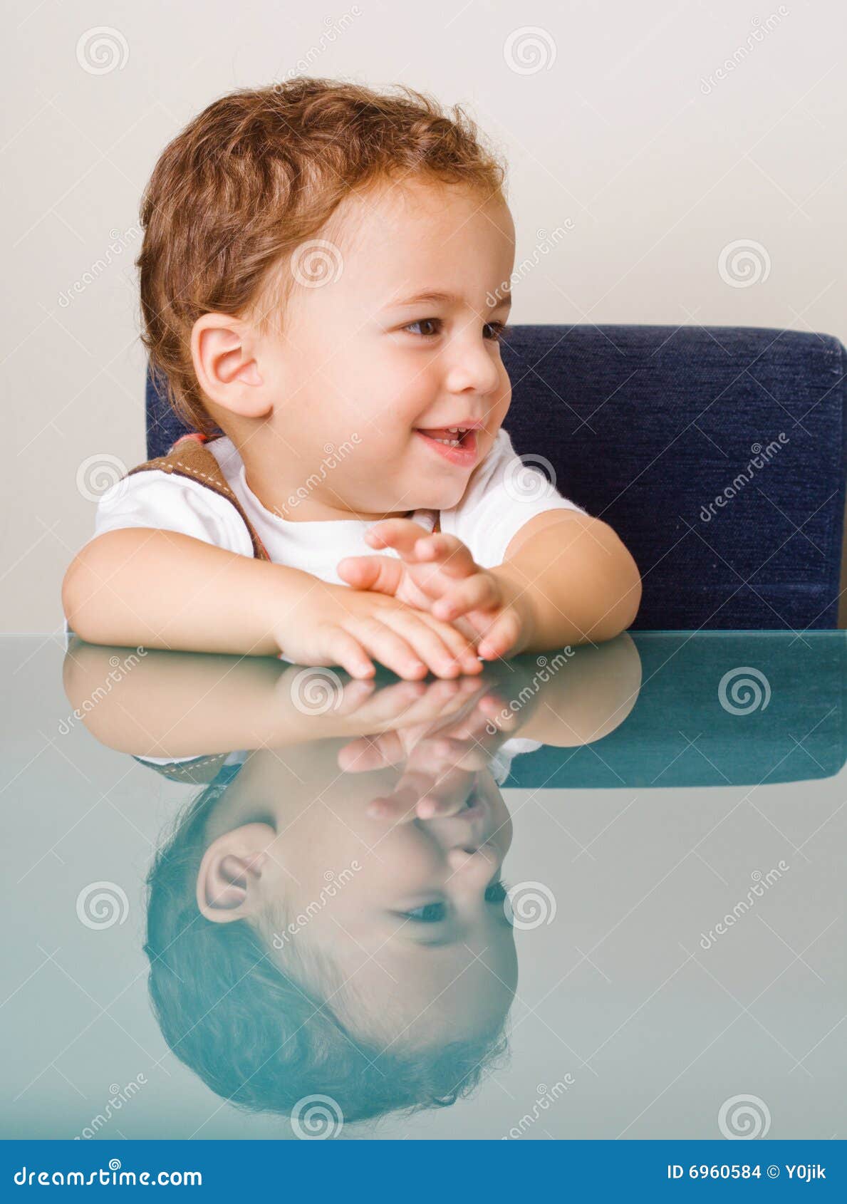 Smiling boy at glass table stock photo. Image of hair - 6960584
