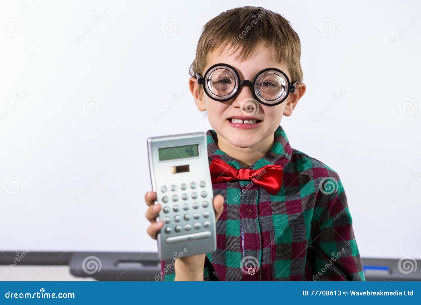 Smiling Boy Holding Calculator in Classroom Stock Image - Image of ...