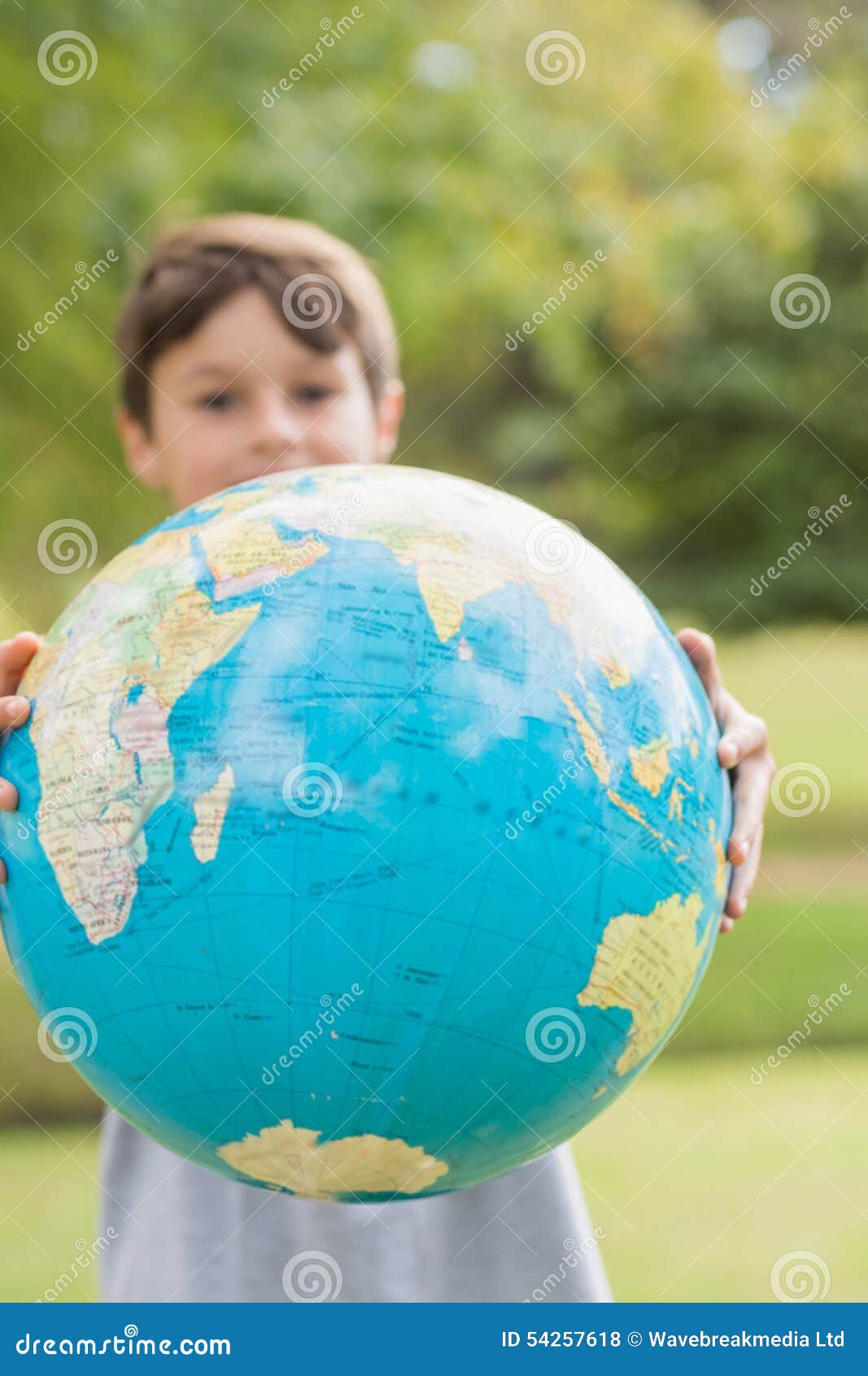 Smiling Boy Holding an Earth Globe in the Park Stock Photo - Image of ...