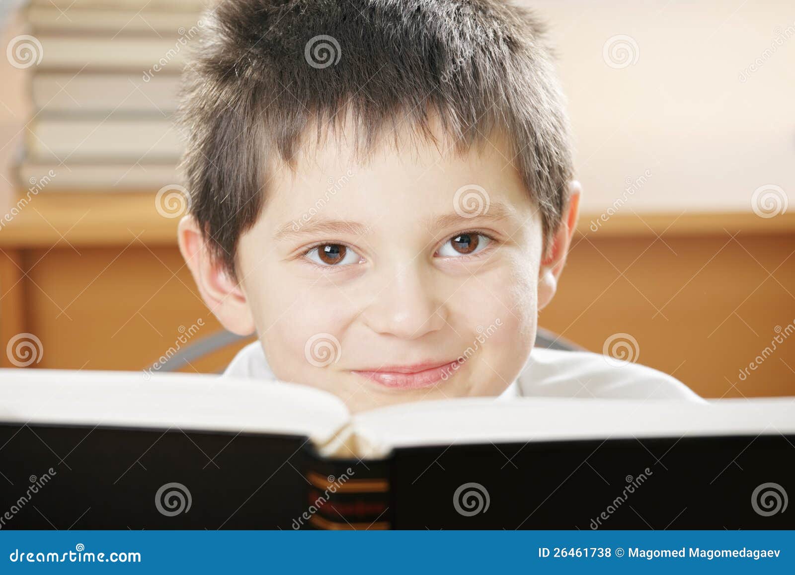 Smiling Boy Looking Over Book Stock Photo - Image of clever, horizontal ...