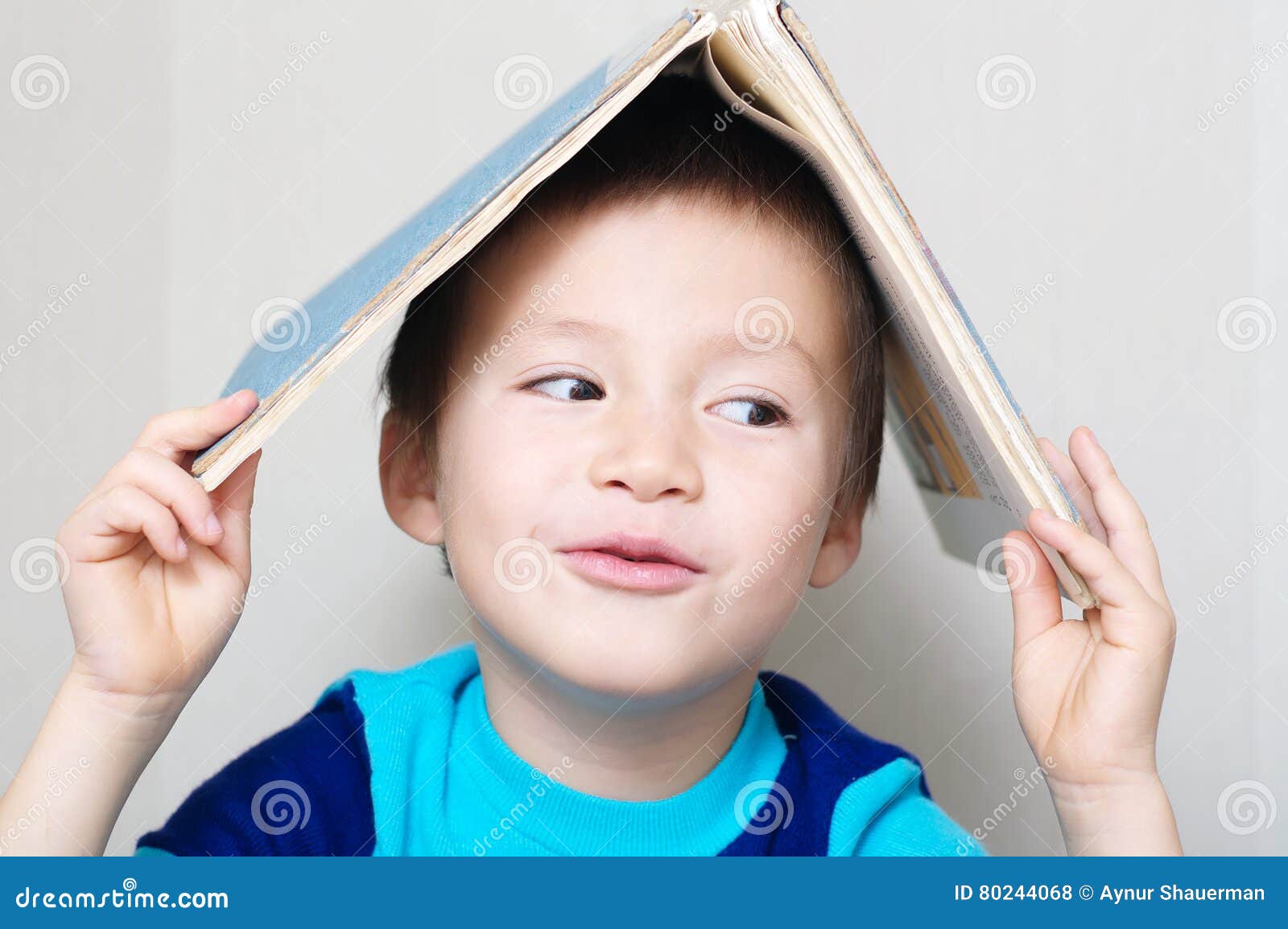 Smiling Boy Looking Right with Book Roof Stock Photo - Image of little ...