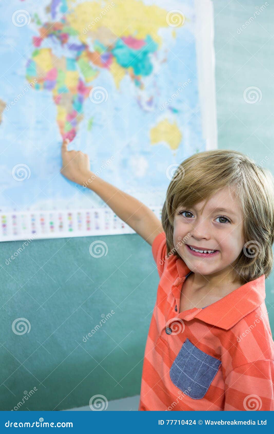 Smiling Boy Pointing on Map in Classroom Stock Photo - Image of ...