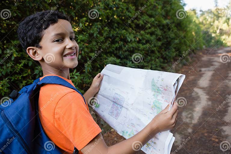 Smiling Boy Reading the Map while Walking on the Path Stock Image ...