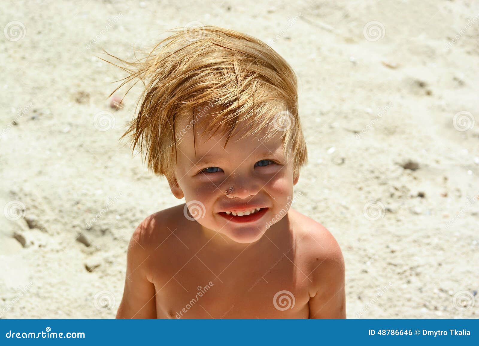 Smiling boy on a sea beach stock photo. Image of family - 48786646