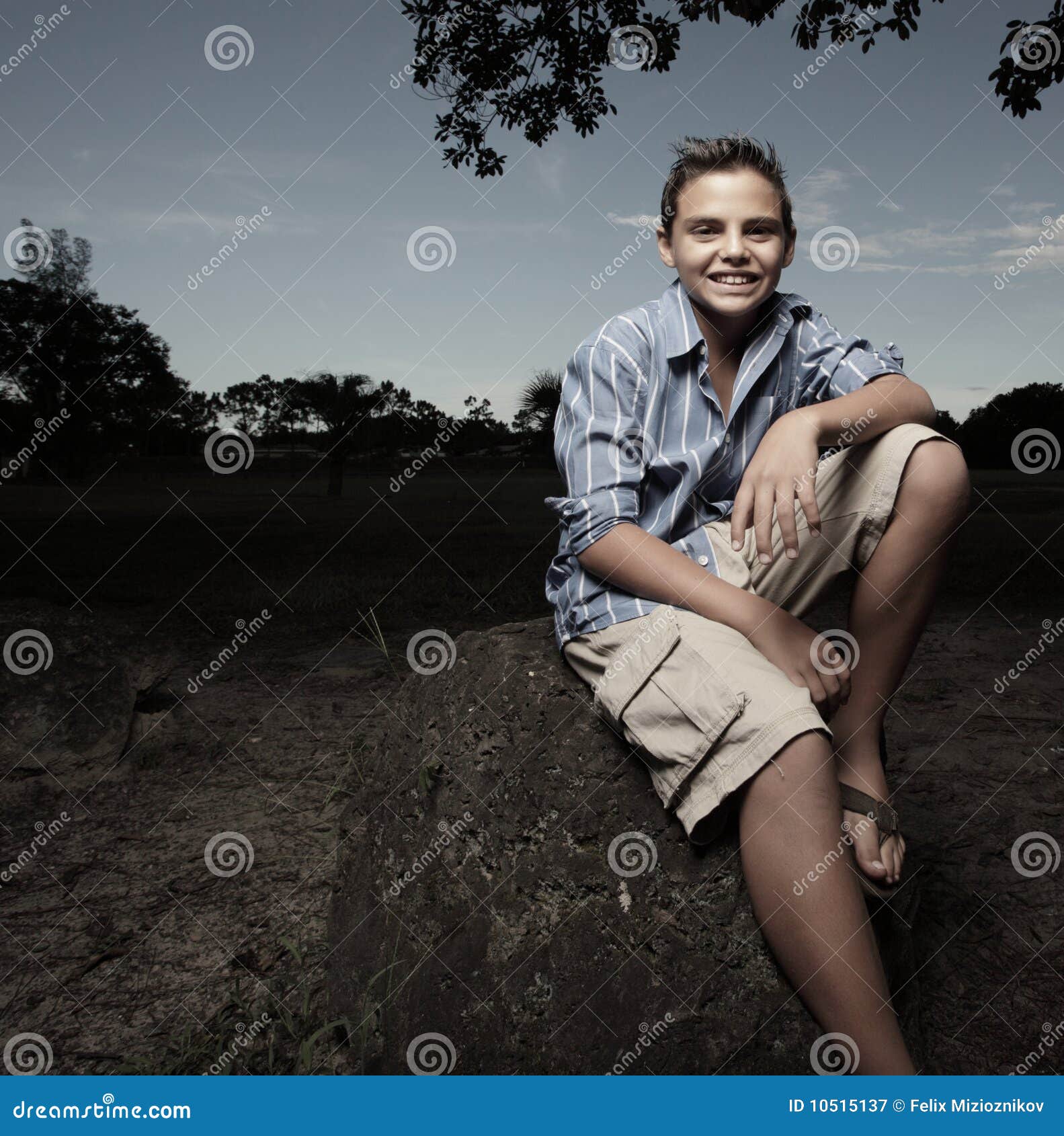 Smiling Boy Sitting on a Rock Stock Image - Image of sitting, happy ...