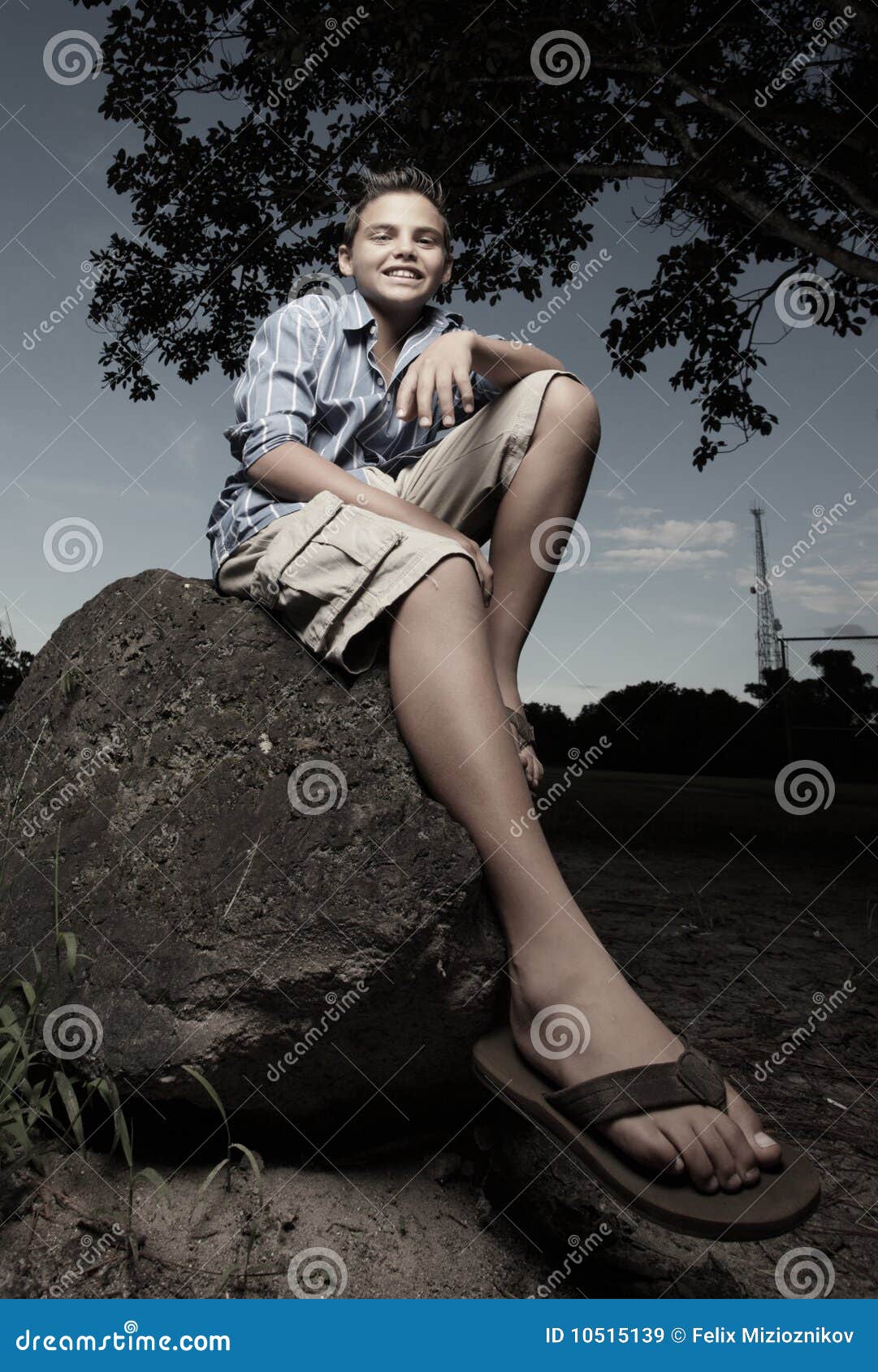 Smiling Boy Sitting on a Rock Stock Image - Image of dusk, happy: 10515139