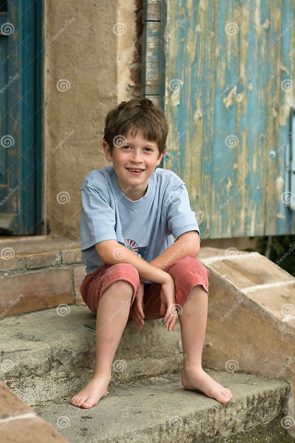 Smiling Boy Sitting on Steps Stock Photo - Image of outside, casual ...