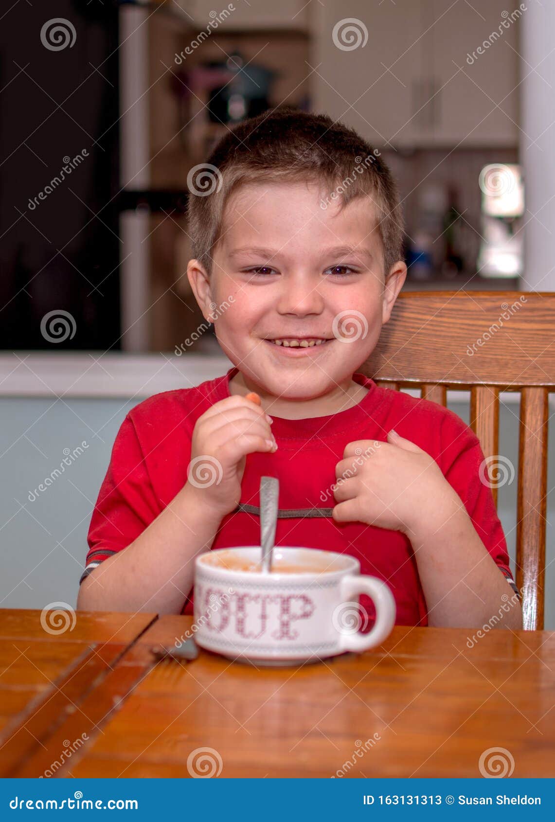 Smiling Boy at the Table with a Cup of Soup Stock Image - Image of ...