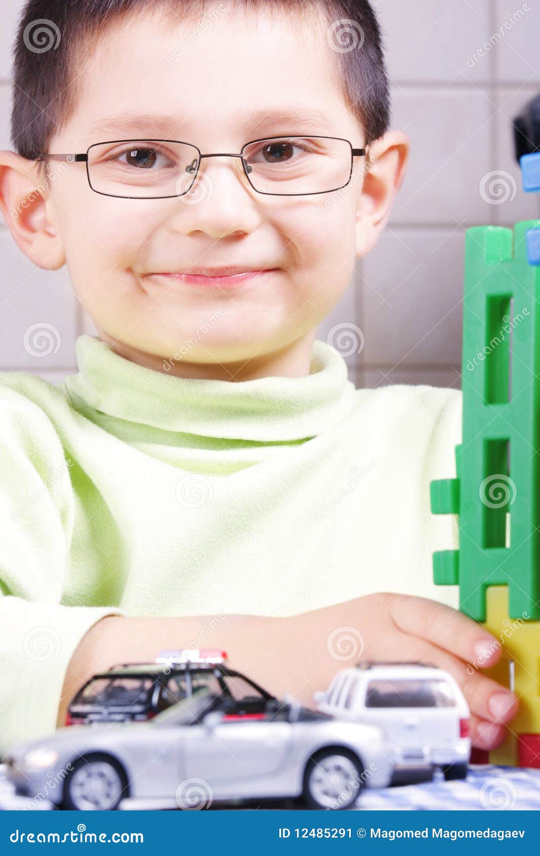 Smiling boy with toys stock image. Image of spectacles - 12485291