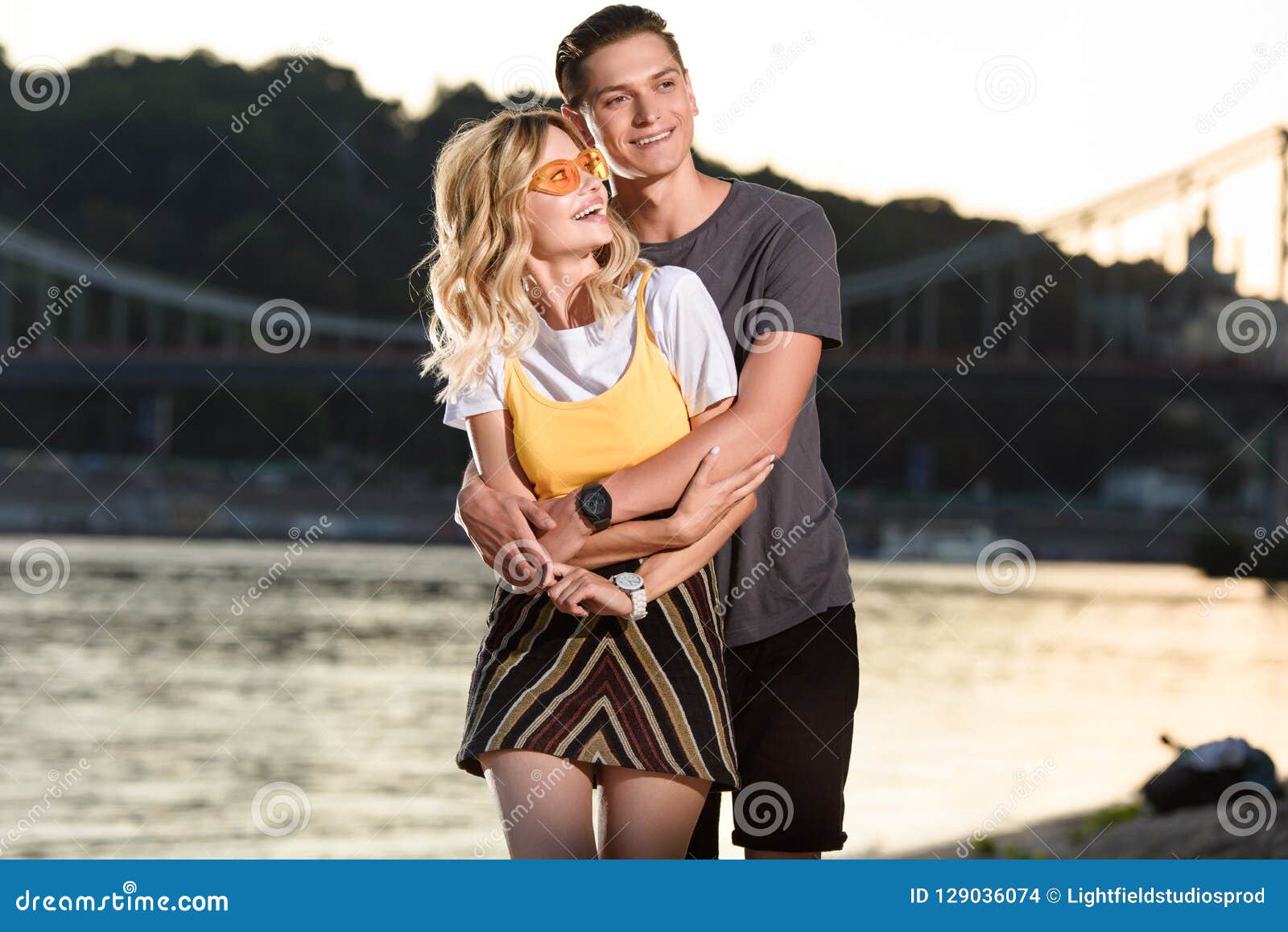 Smiling Boyfriend Hugging Girlfriend on River Beach Stock Photo - Image ...