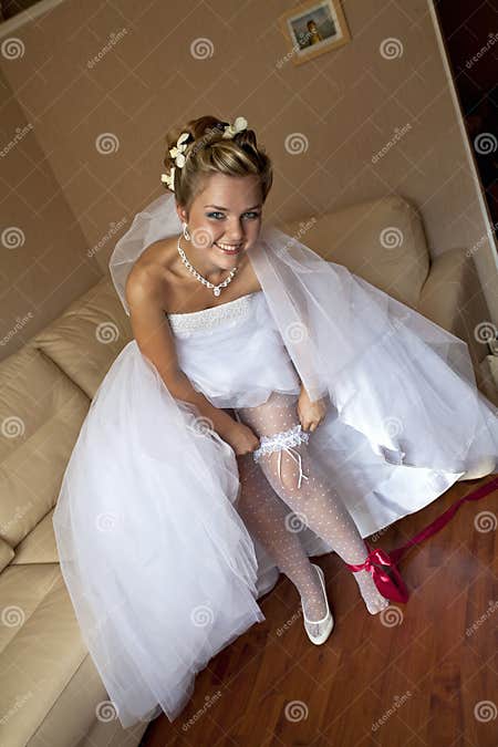 Smiling Bride Setting the Garter Stock Photo - Image of fianc ...
