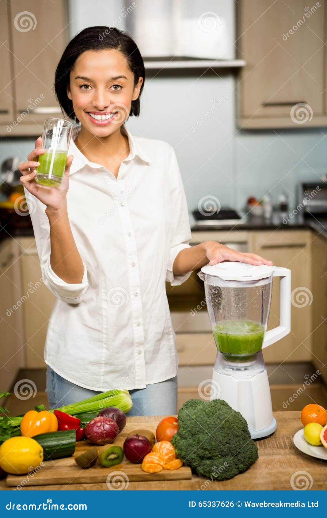 Smiling Brunette Holding Glass of Smoothie Stock Photo - Image of sink ...