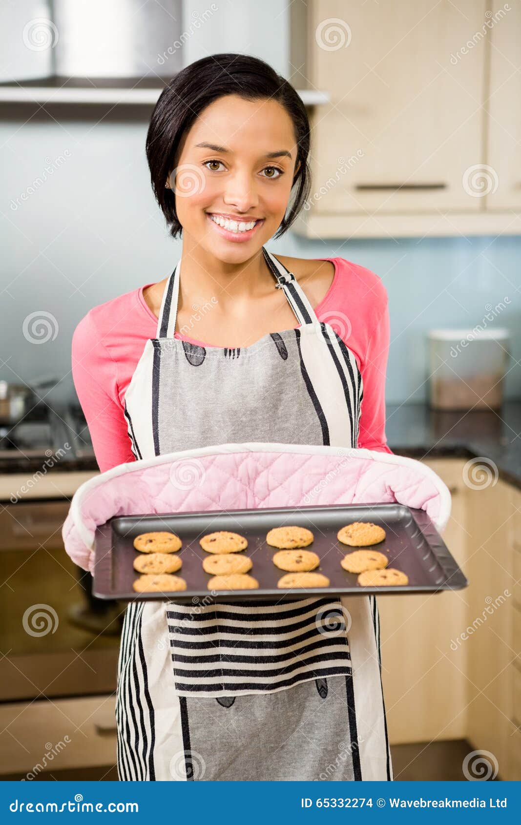 Smiling Brunette Showing Biscuits on Baking Tin Stock Photo - Image of ...