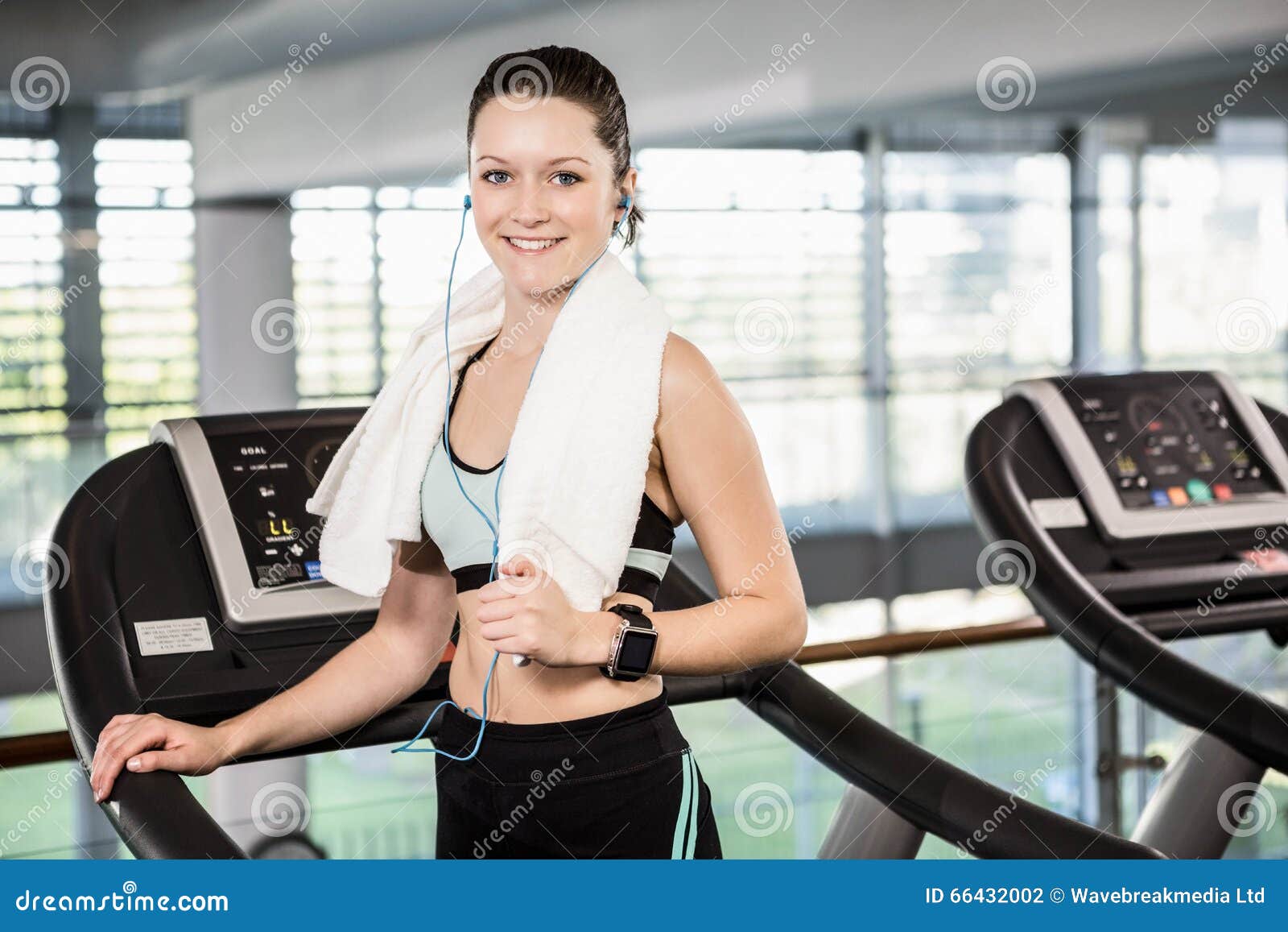 Smiling Brunette on Treadmill Looking at the Camera Stock Photo - Image ...