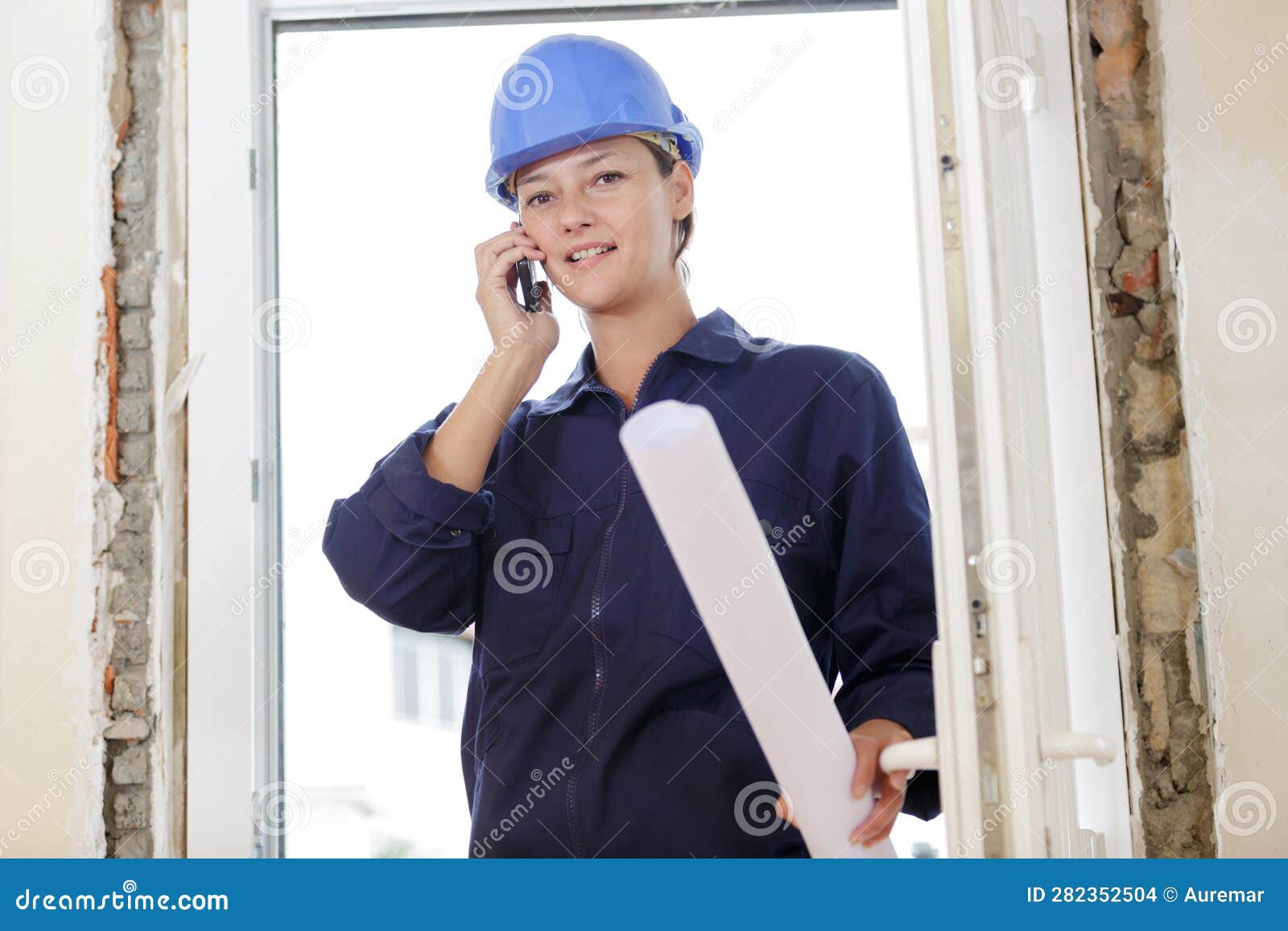 Smiling Builder on Phone Looking at Camera Stock Photo - Image of happy ...