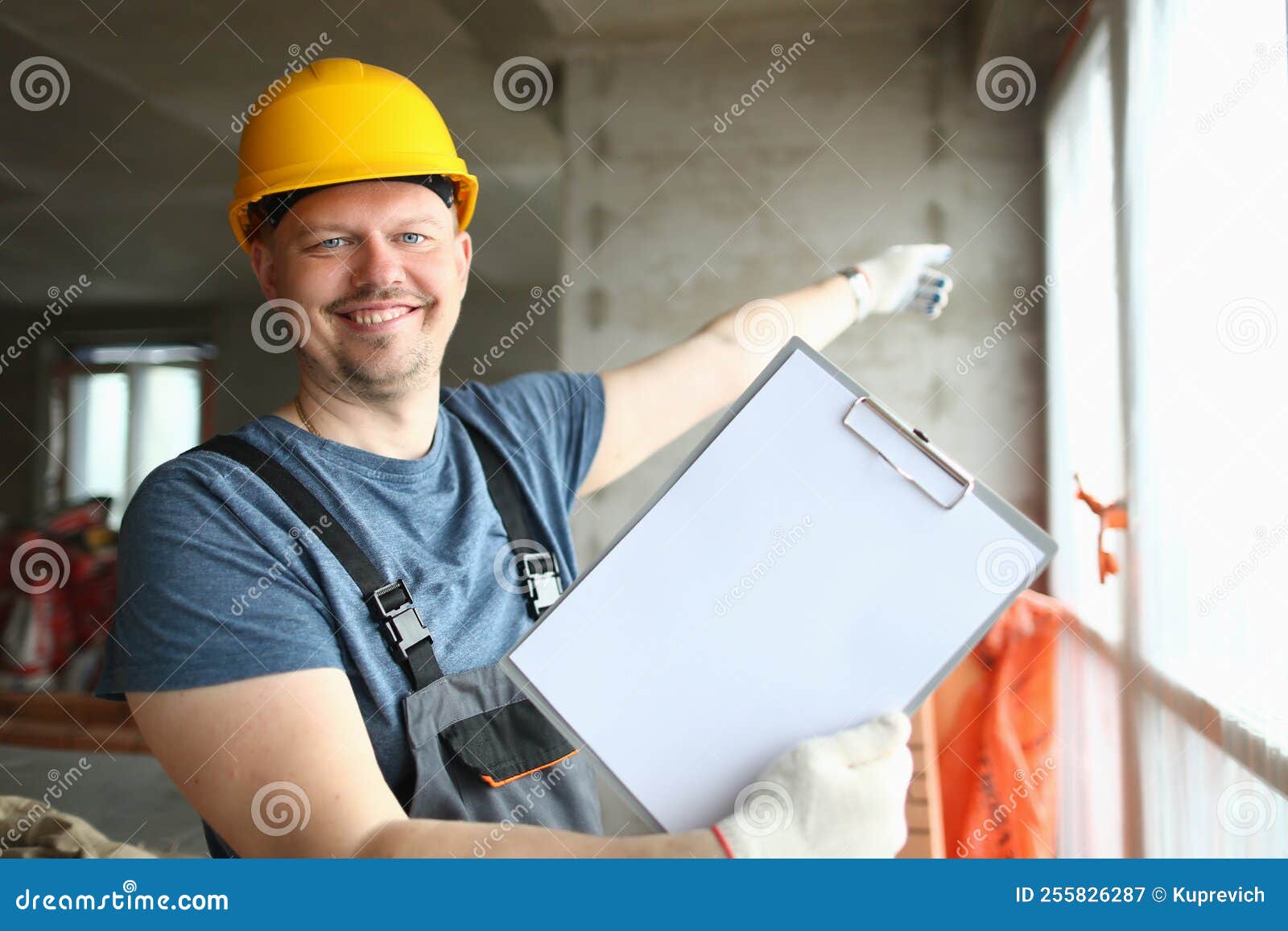 Smiling Builder Worker in Hard Hat Holding Blank Sheet of Paper on ...